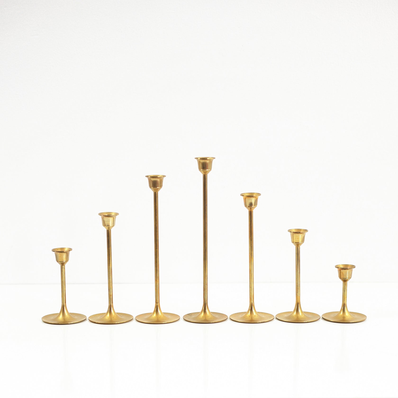 SOLD - Set of Seven Mid Century Modern Brass Candlesticks – Wise Apple ...